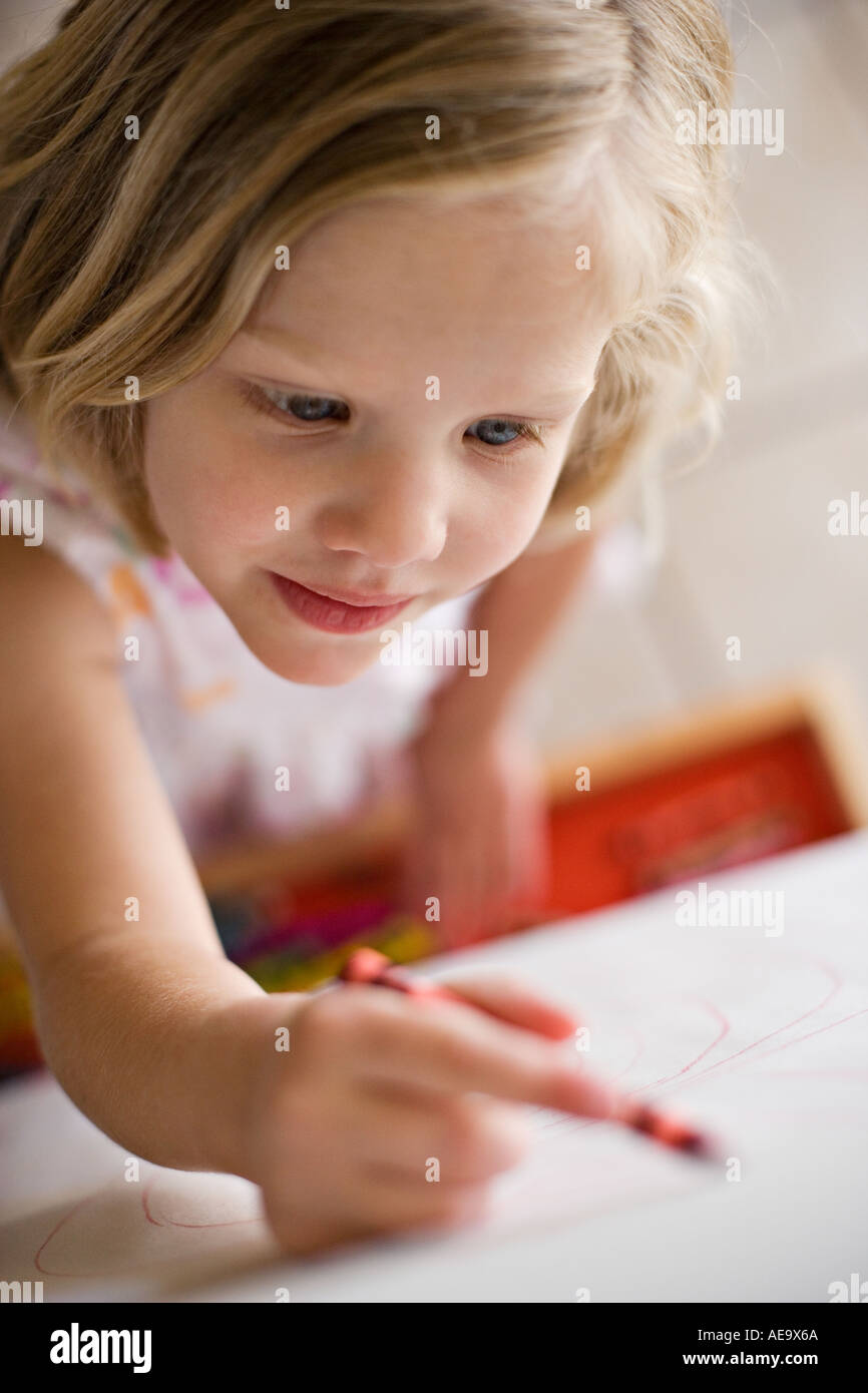Young girl drawing with crayon Stock Photo - Alamy