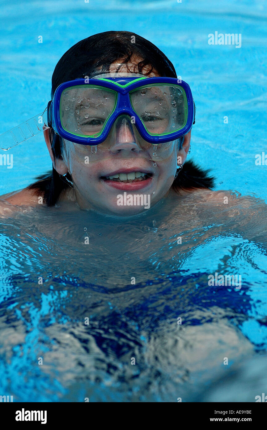 Boy with goggles in swimming pool Stock Photo - Alamy