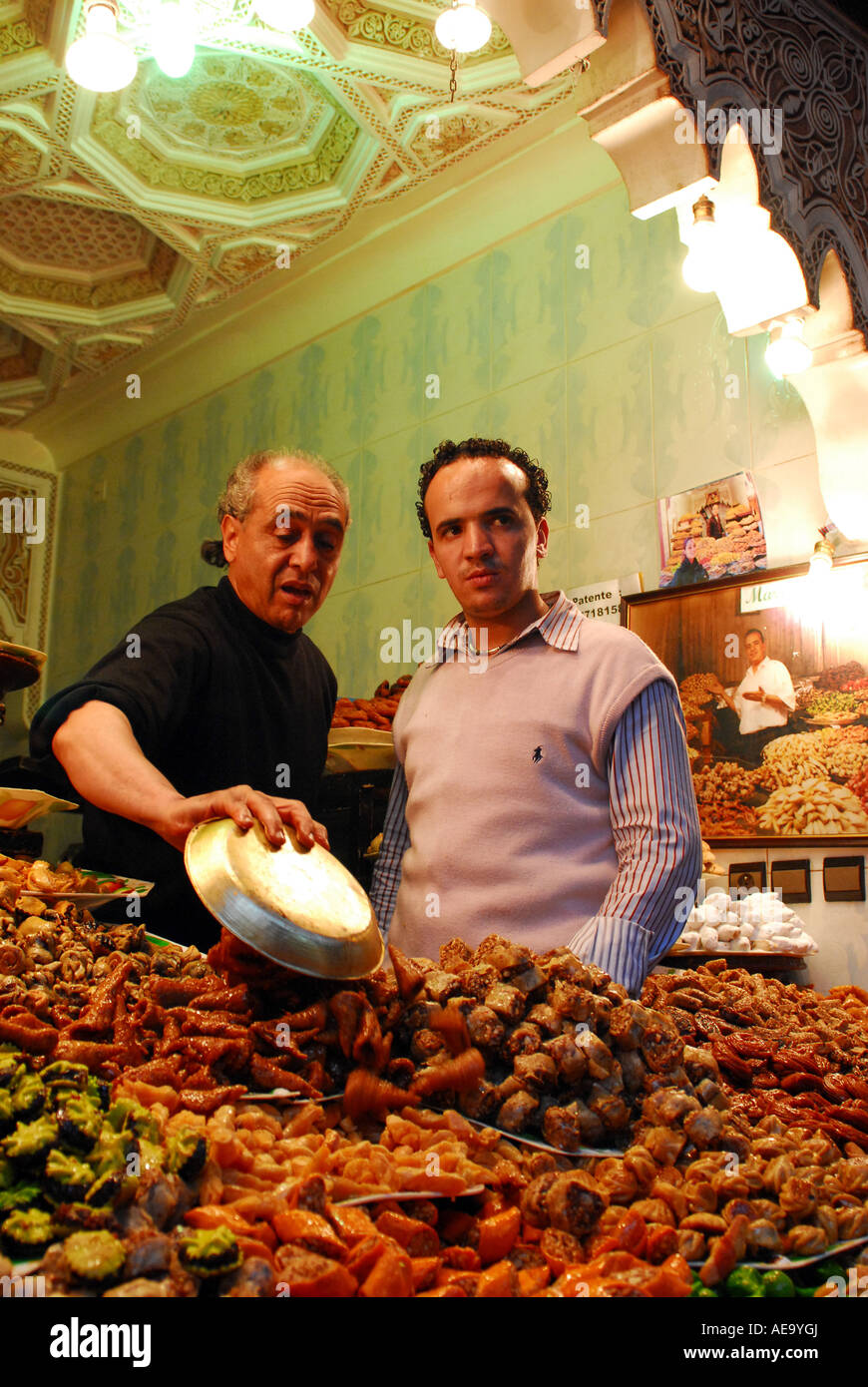 Two vendors at their stall selling traditional Moroccan sweets in the ...