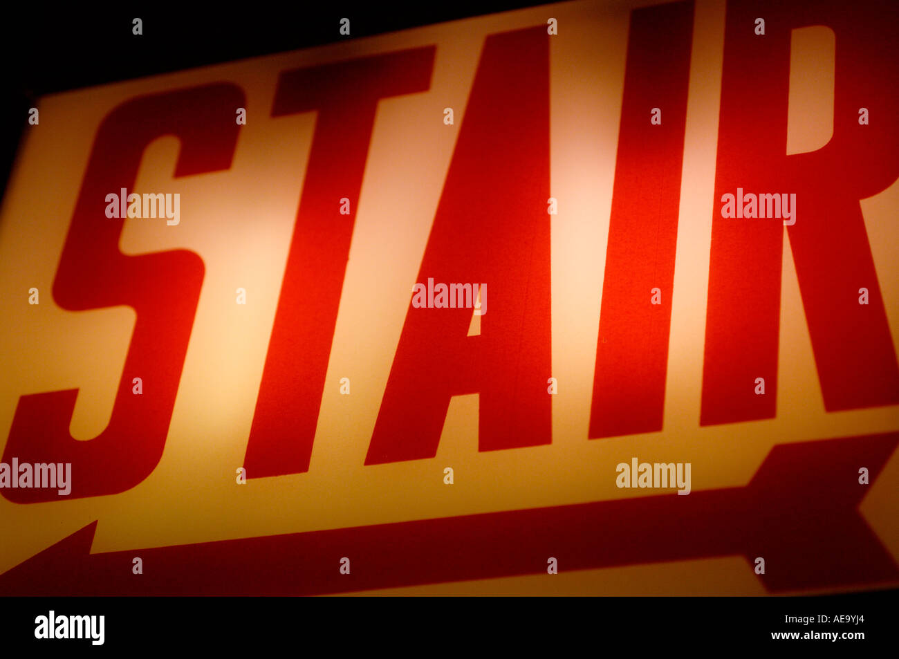 Illuminated stair sign with arrow Stock Photo - Alamy