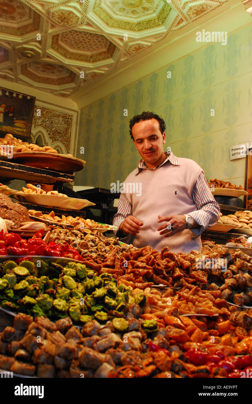 A vendor at his stall selling traditional Moroccan sweets in the souk ...