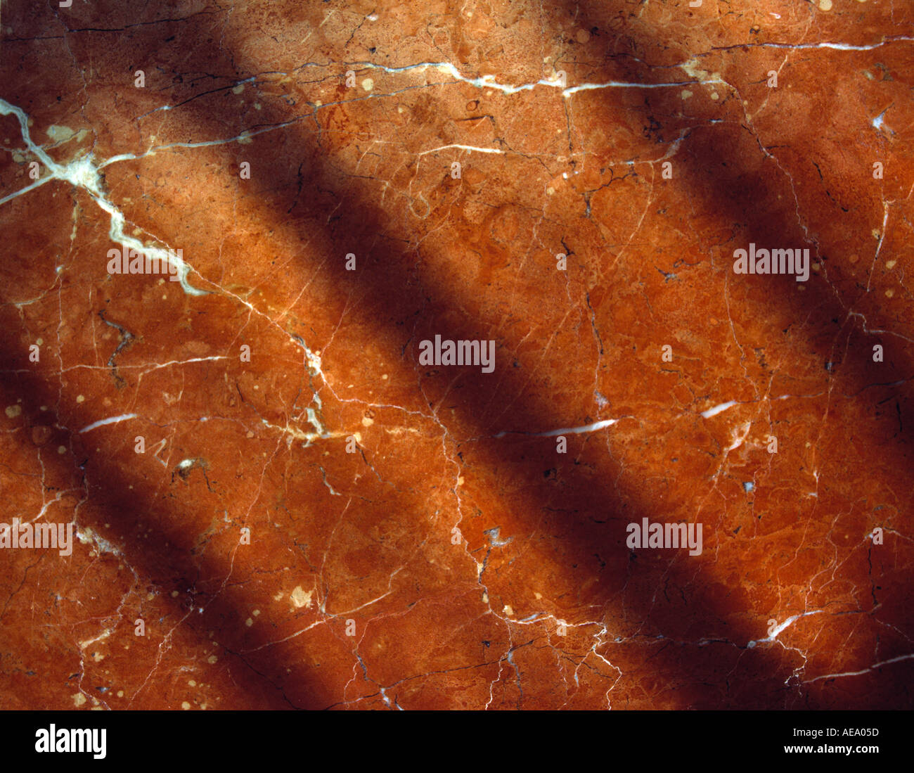 Red marble with diagonal shadows Stock Photo - Alamy