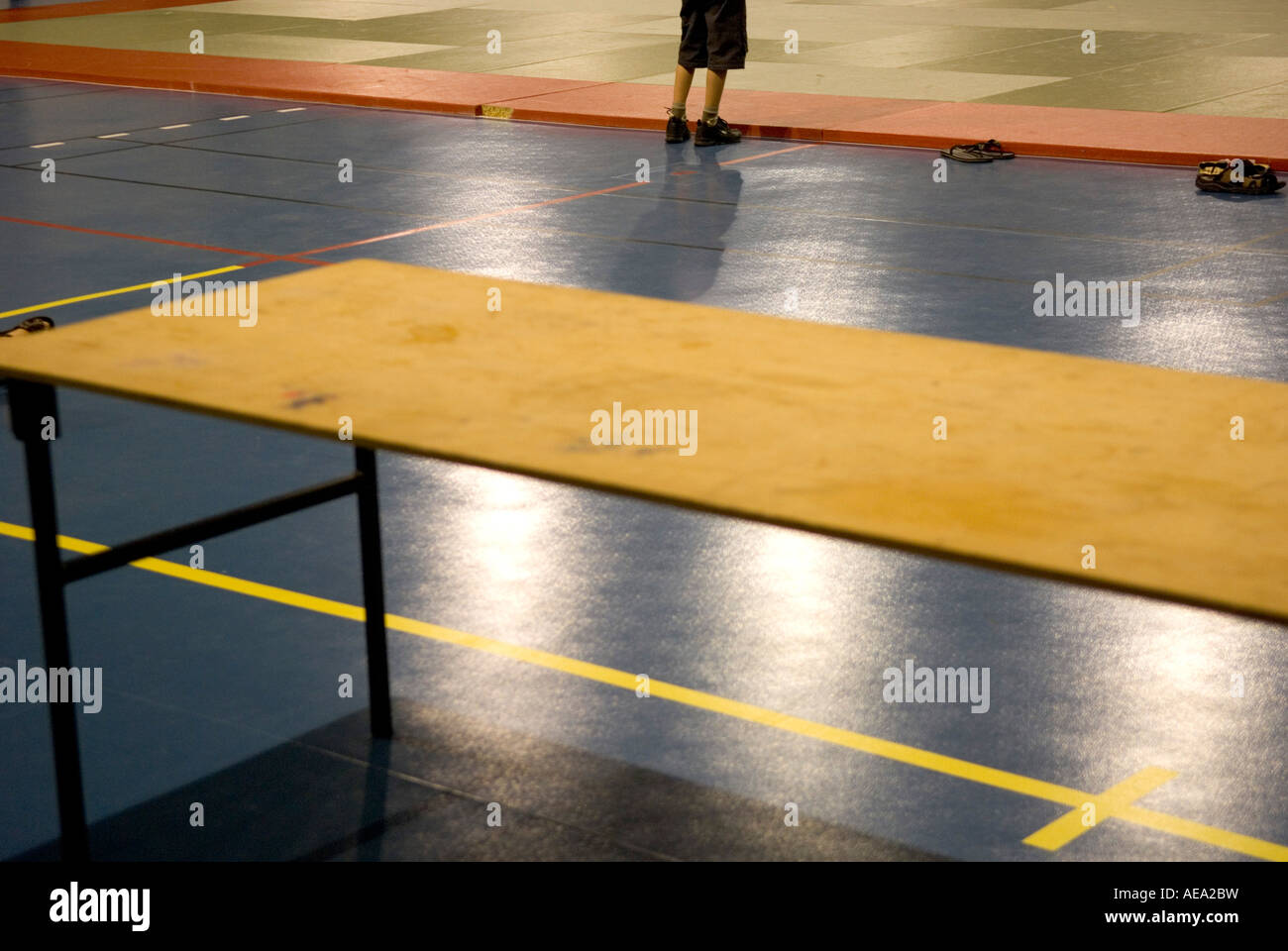 Gym - a cropped view of a table with child standing on the edge of a ...