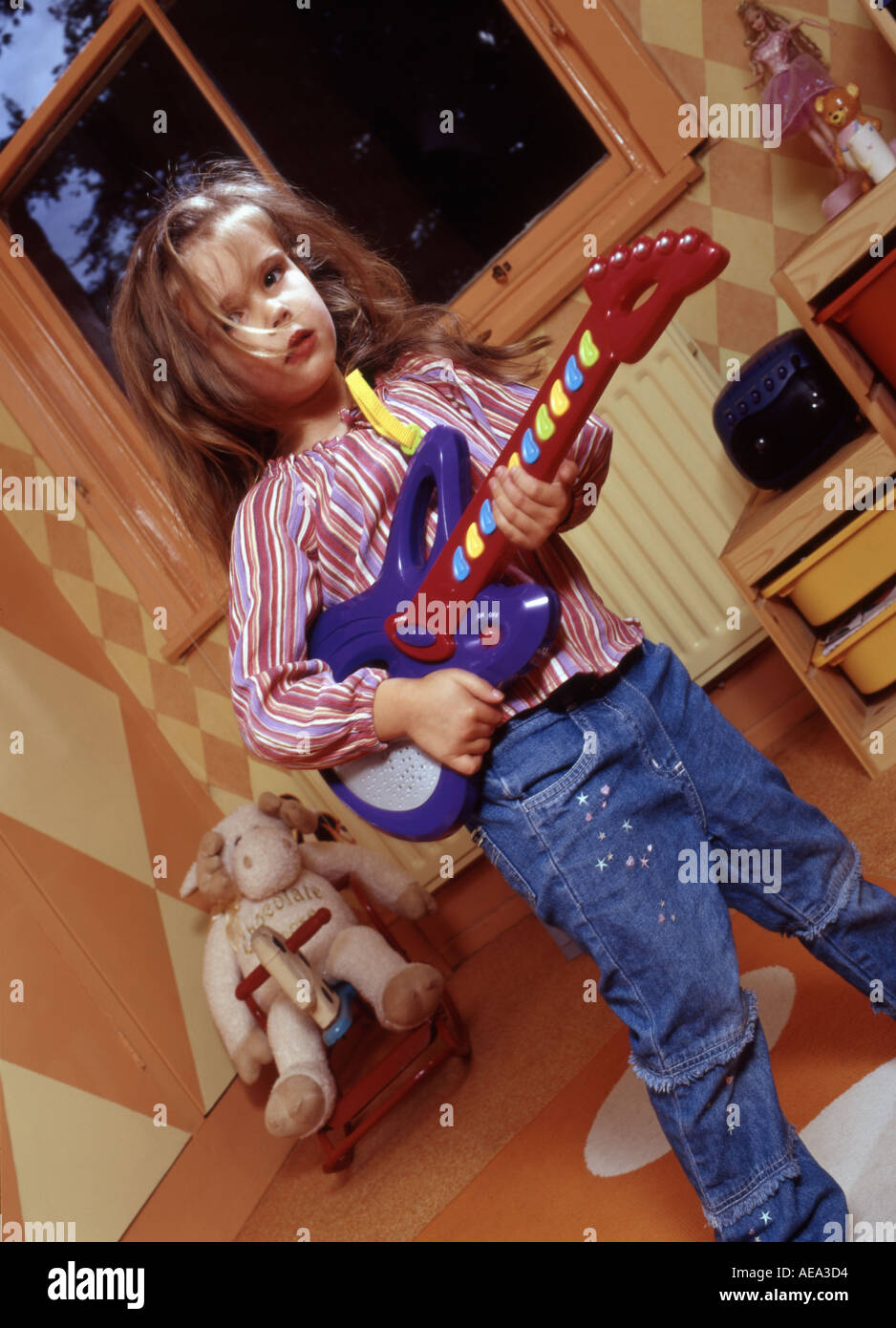 Little girl playing at being a pop rock star in her playroom Stock ...