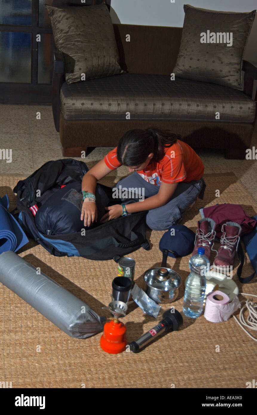 A young girl of 12 packing her backpack for a camping trip Stock Photo ...