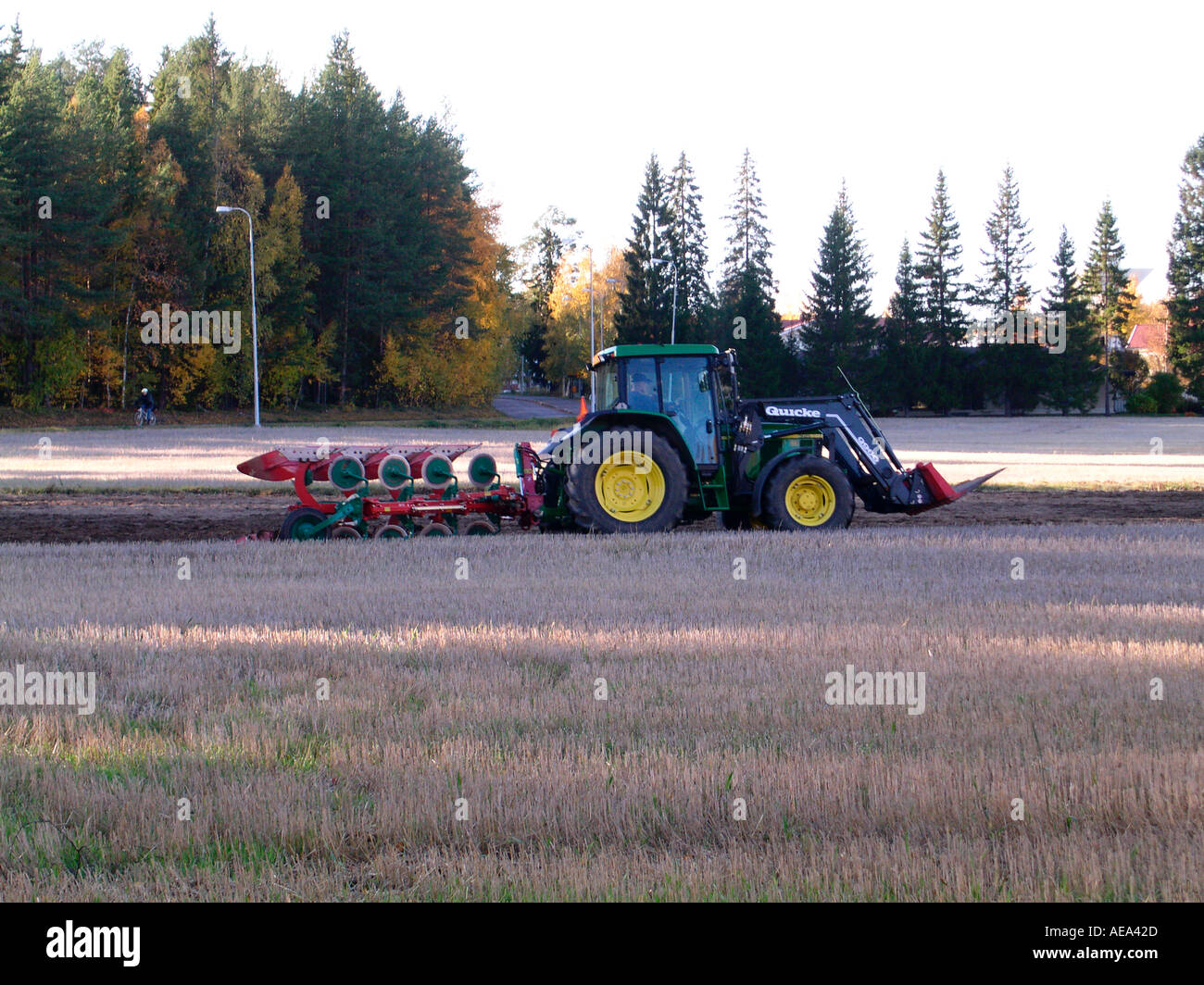Farmer ploughing a field in his tractor Stock Photo - Alamy