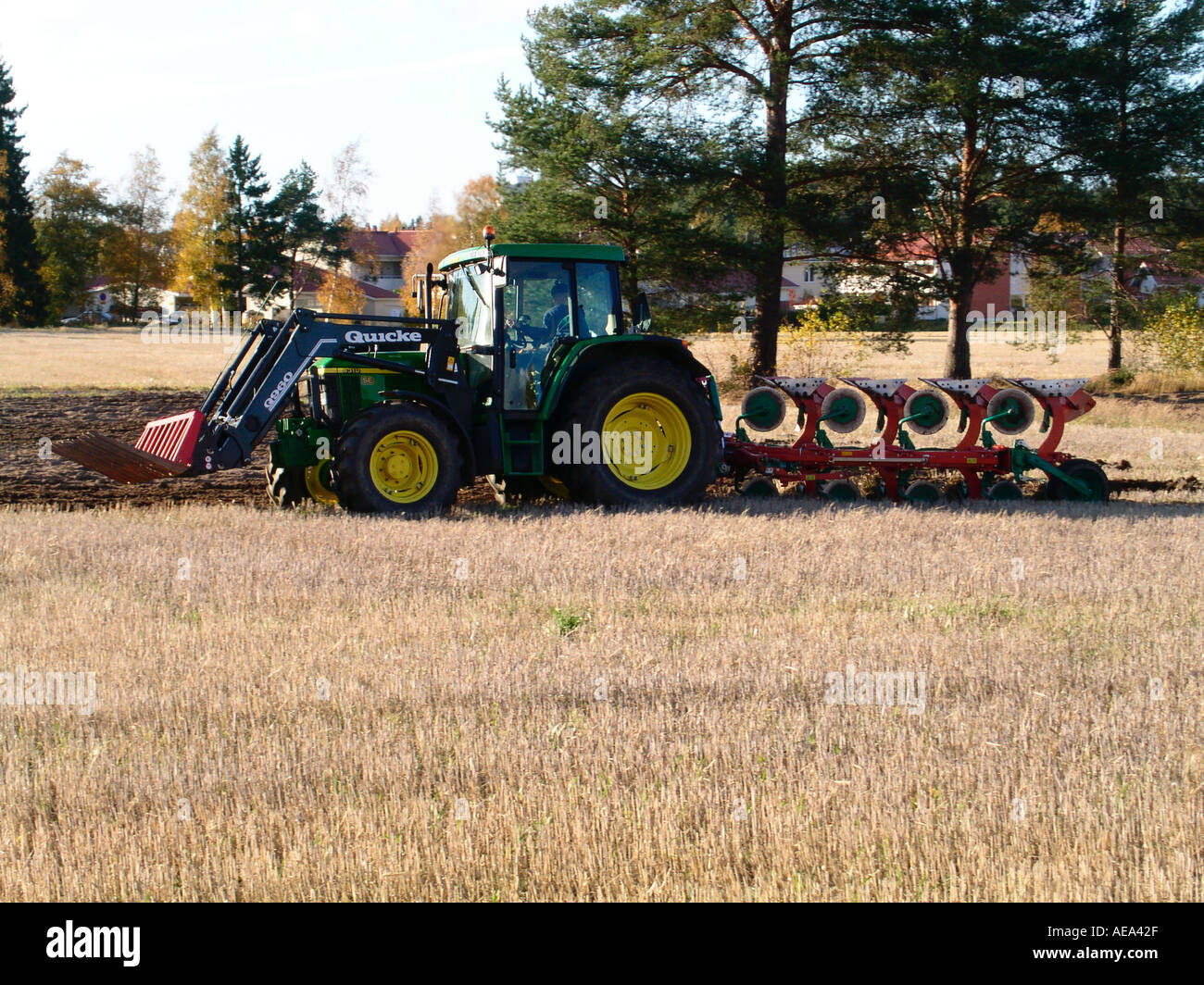Farmer ploughing a field in his tractor Stock Photo - Alamy