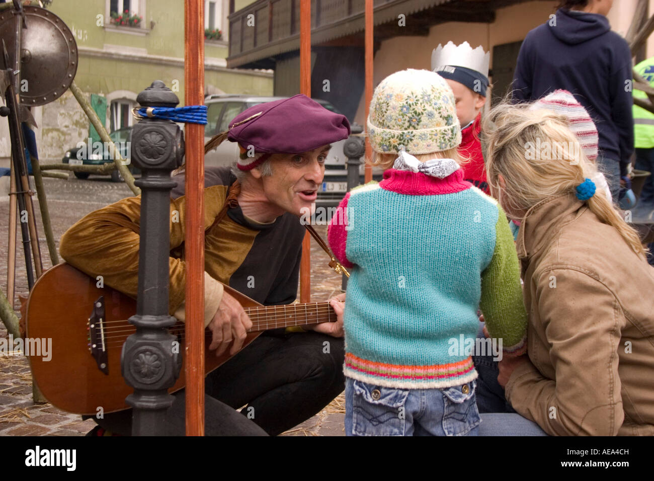 Minstrel sings to children at medieval festival in Kamnik, Slovenia ...