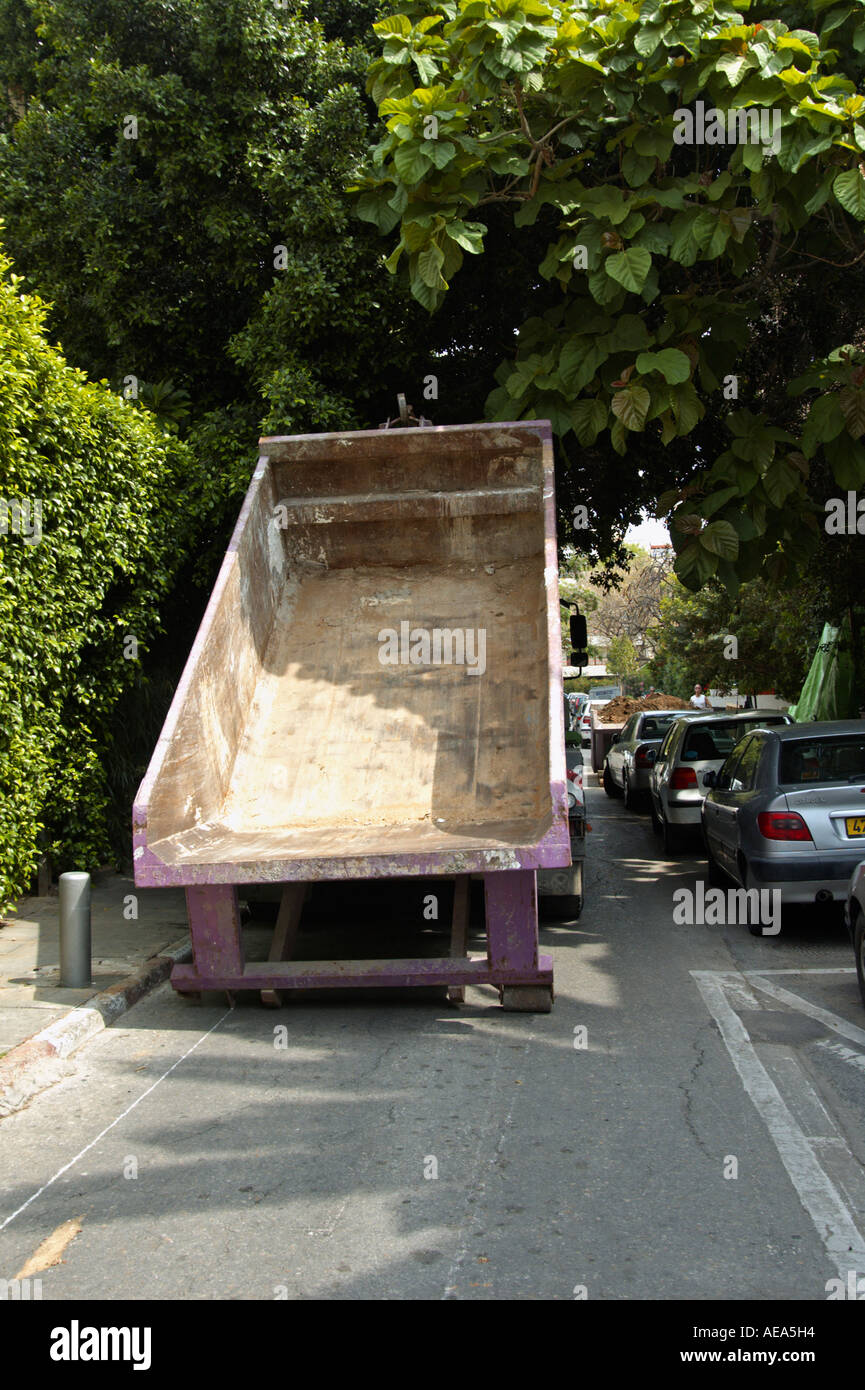 Truck unloading a container for building material waste Stock Photo - Alamy