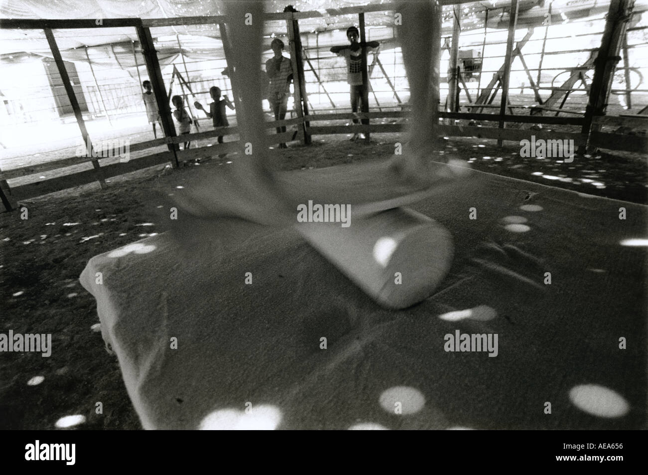 View of child acrobat feet balancing himself on rudimentary circus ...