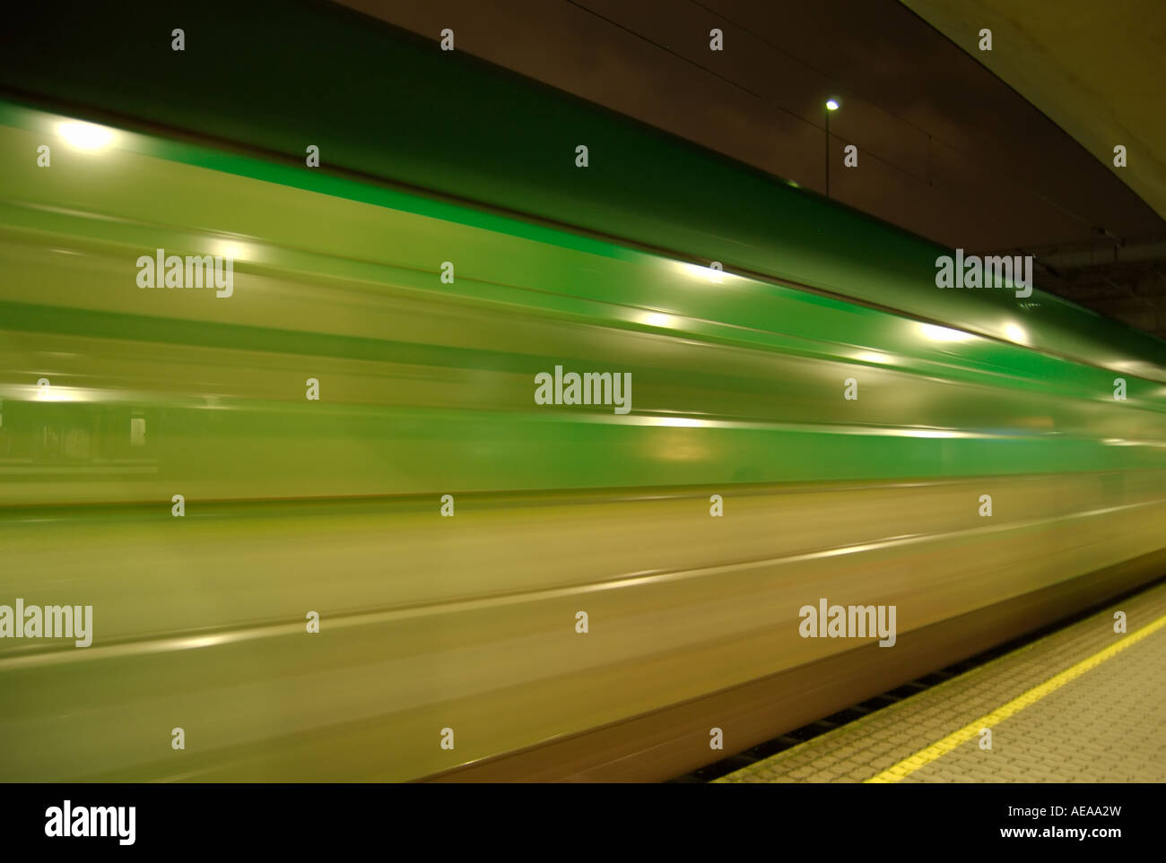 Train passing by station platform at high speed Stock Photo - Alamy