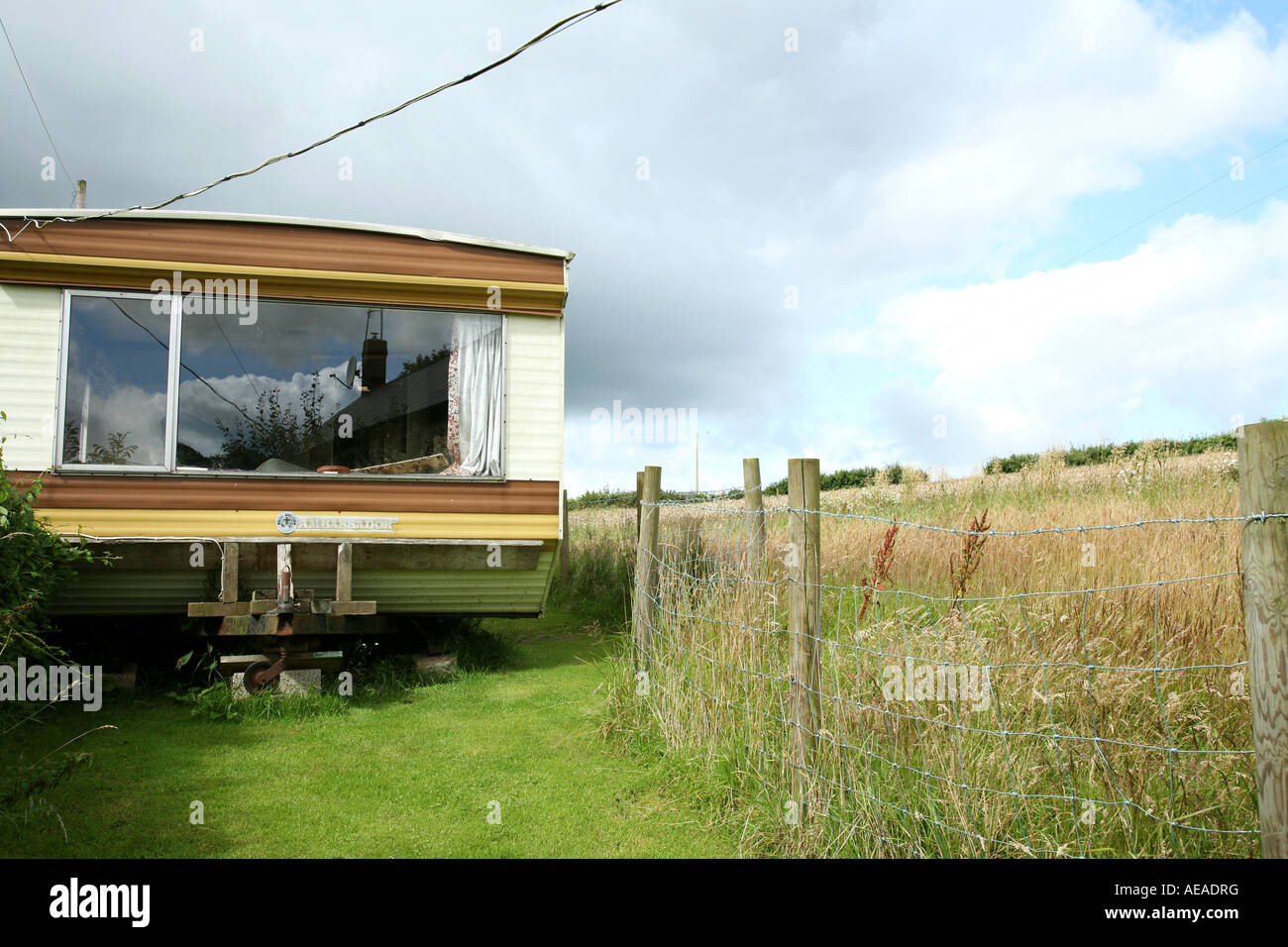 A rural landscape with a static caravan on a field Stock Photo - Alamy