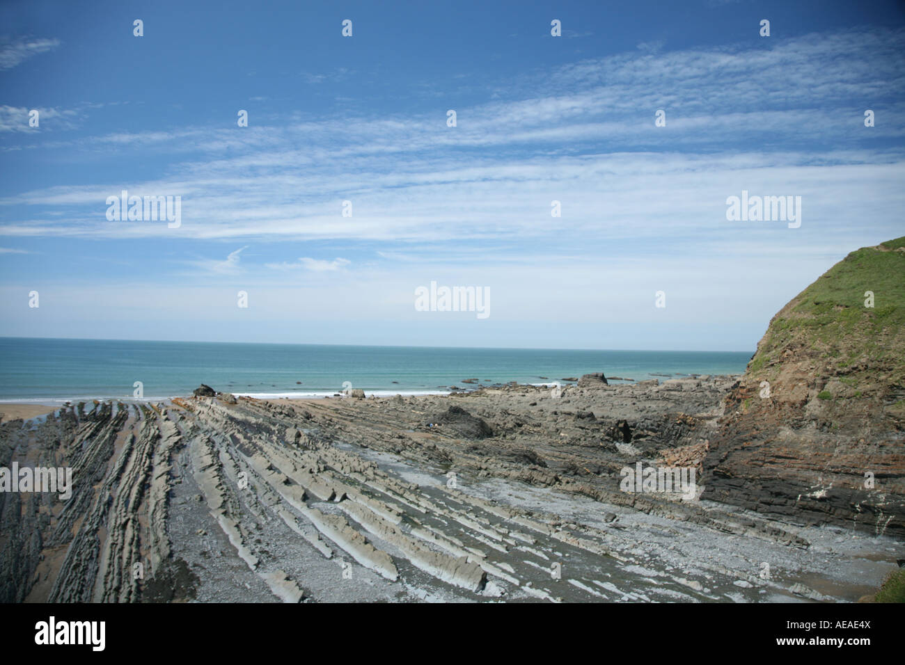 welcome bay in devon with a bright red van parked Stock Photo - Alamy