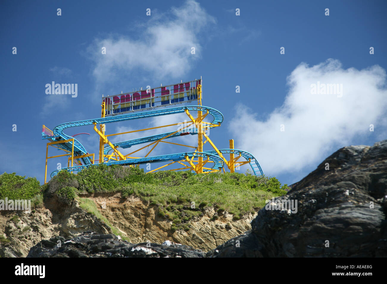 a fair ground ride on top of a hill in newquay cornwall Stock Photo - Alamy