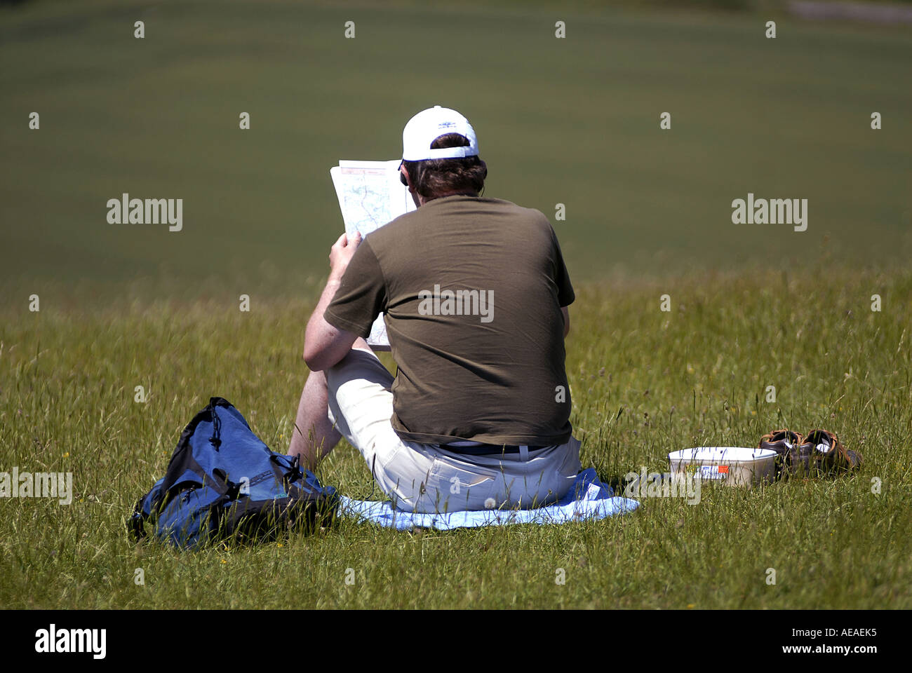 Man sitting grass summer map resting rambler walker hi-res stock ...