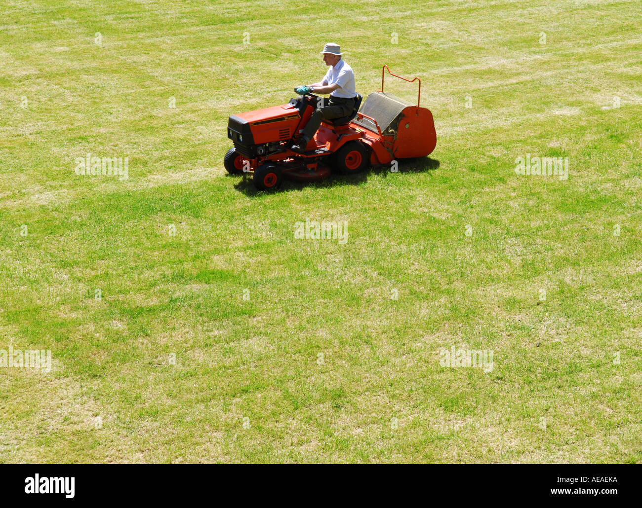 Mowing lawn on a tractor lawn mower Stock Photo - Alamy