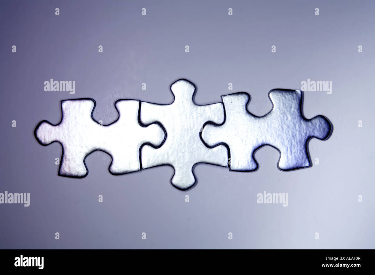 Three puzzle pieces connected Stock Photo - Alamy