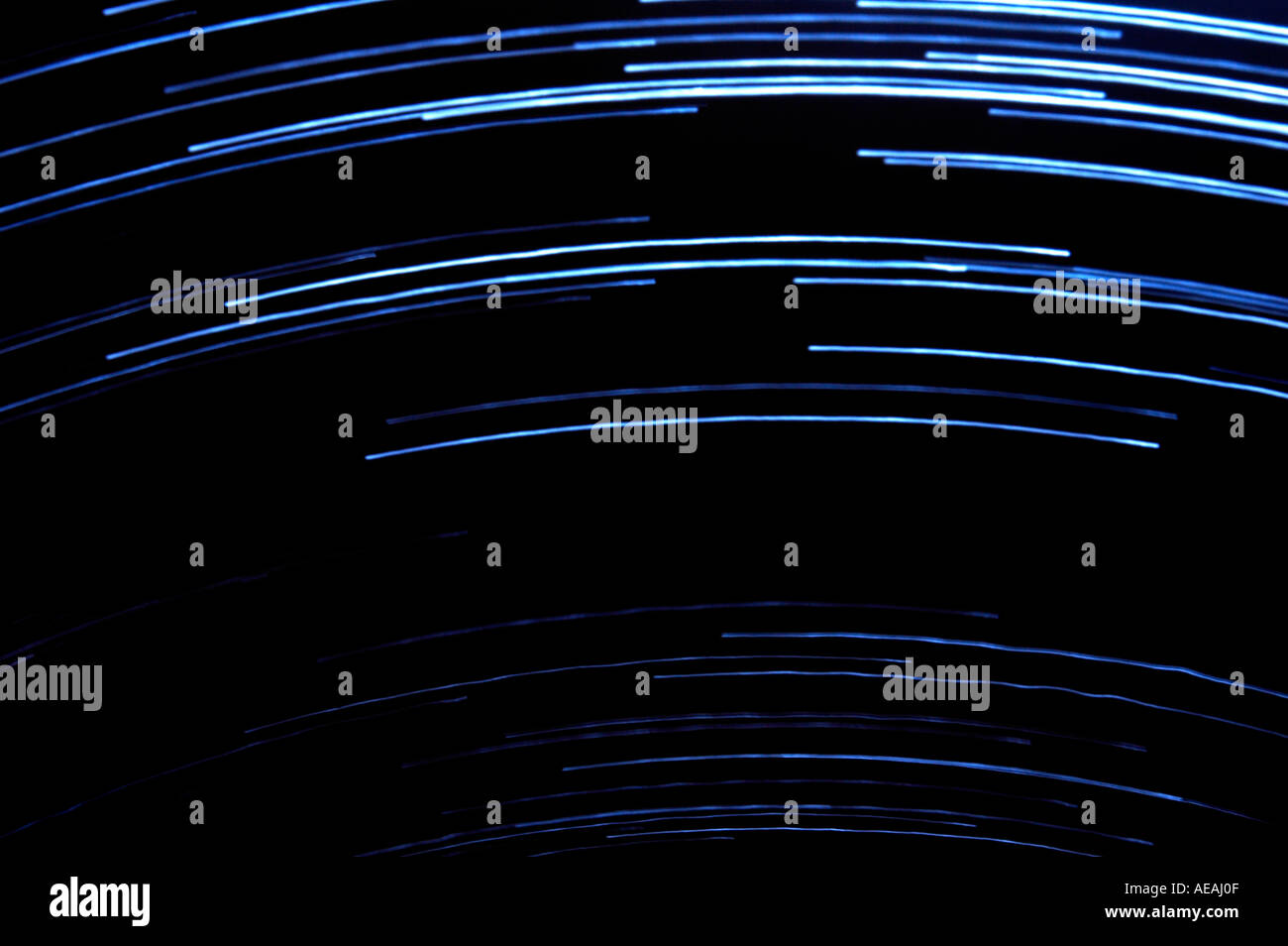star trail effect blue streaks against black sky Stock Photo - Alamy