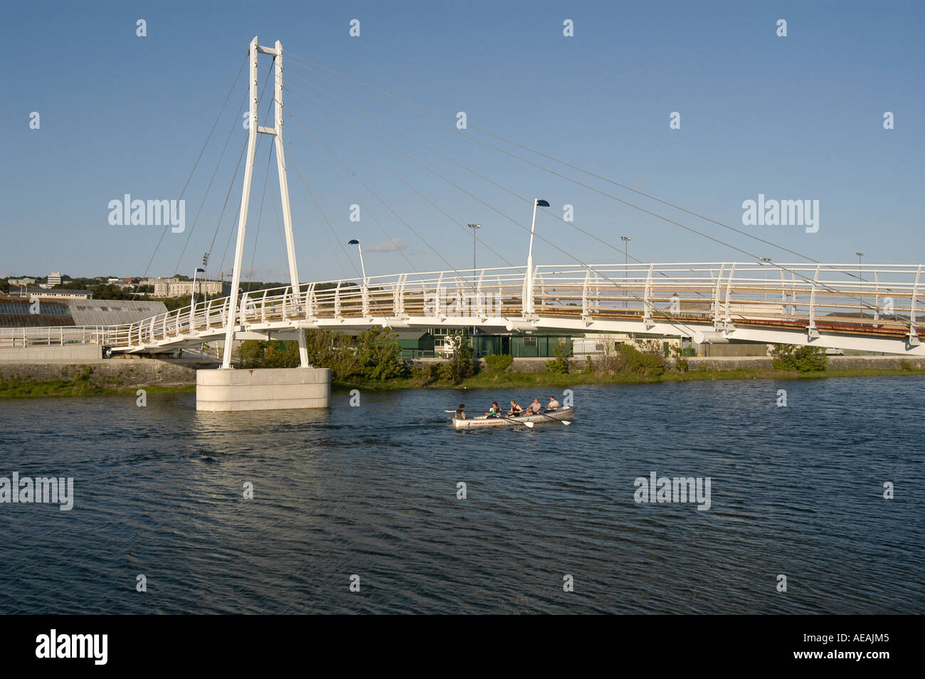 rowing a longboat under the footbridge over the River Rheidol ...