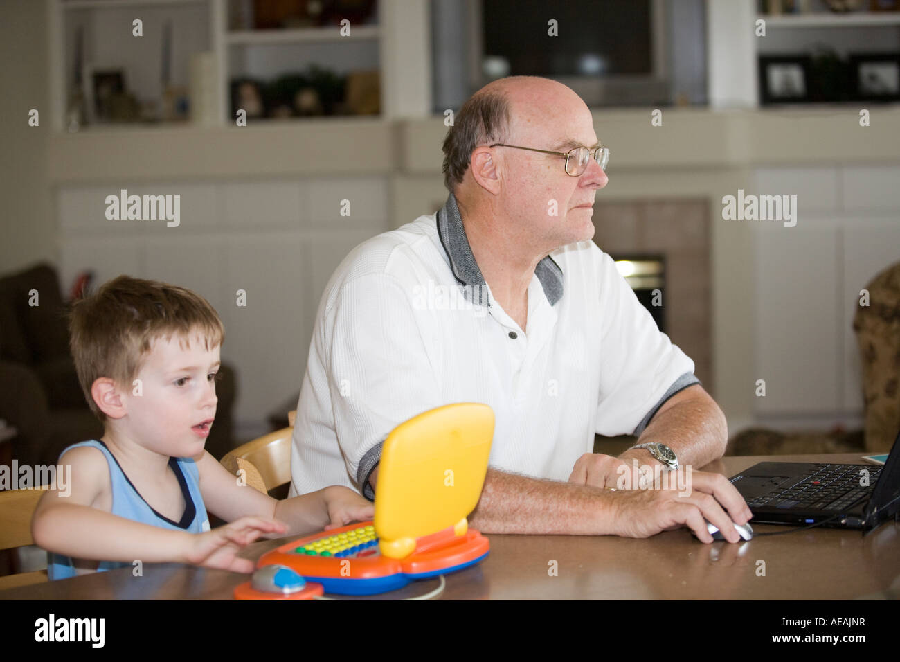 People-Grandfather and Grandson working on computer Stock Photo - Alamy