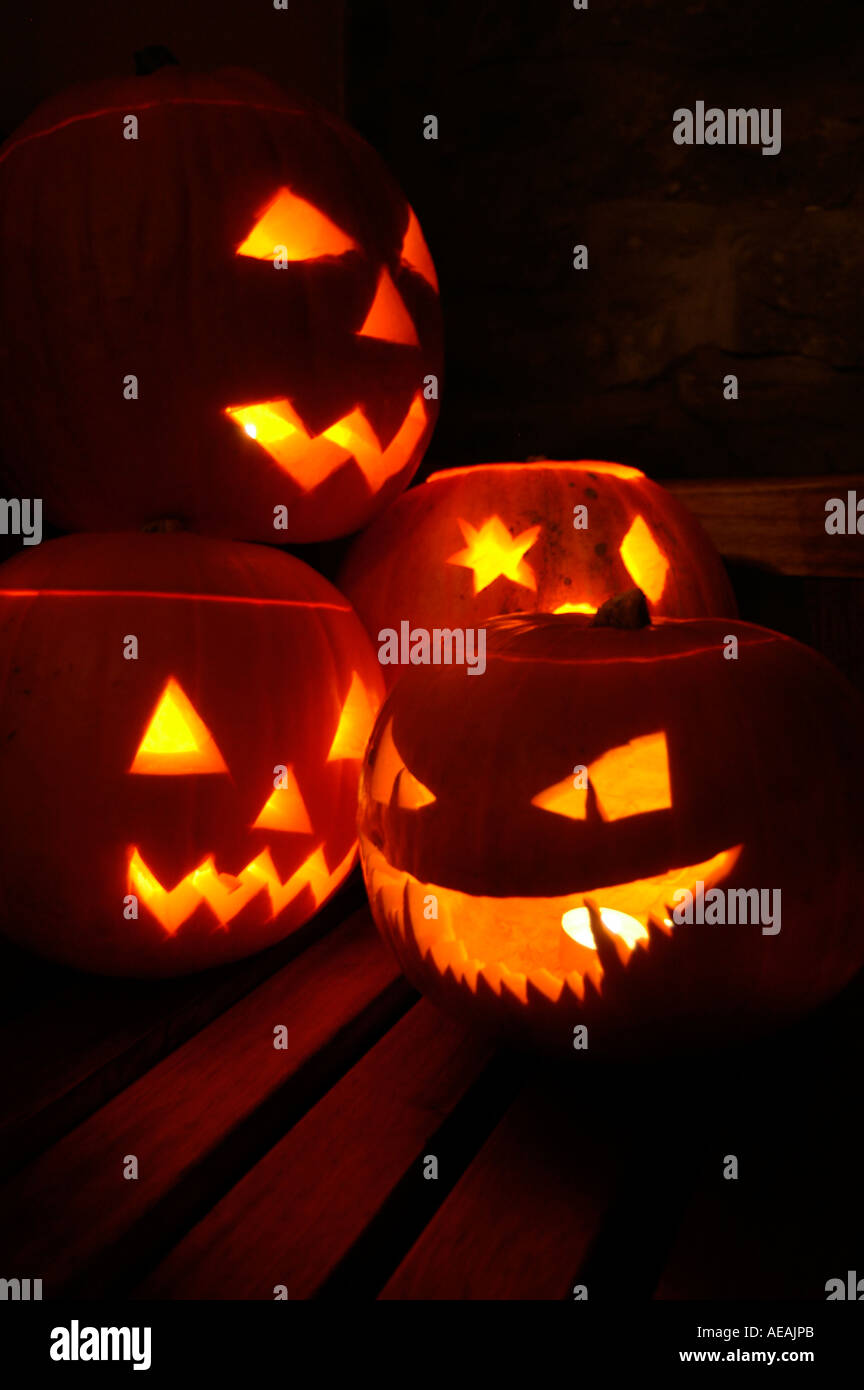 spooky eerie Halloween pumpkins with carved faces and candles lit ...