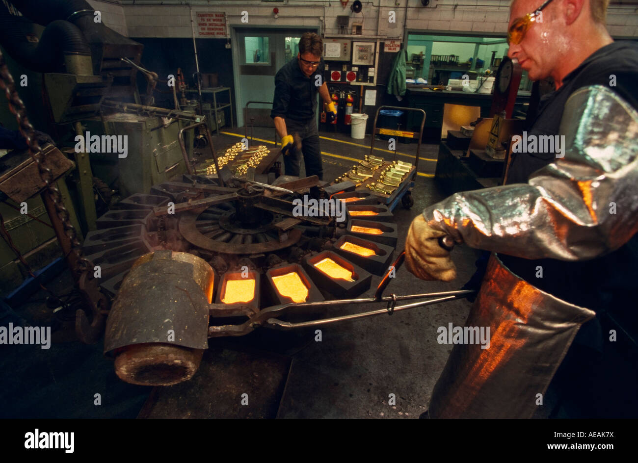 Pouring 99.3% pure gold into anode molds for final purifying, Western ...