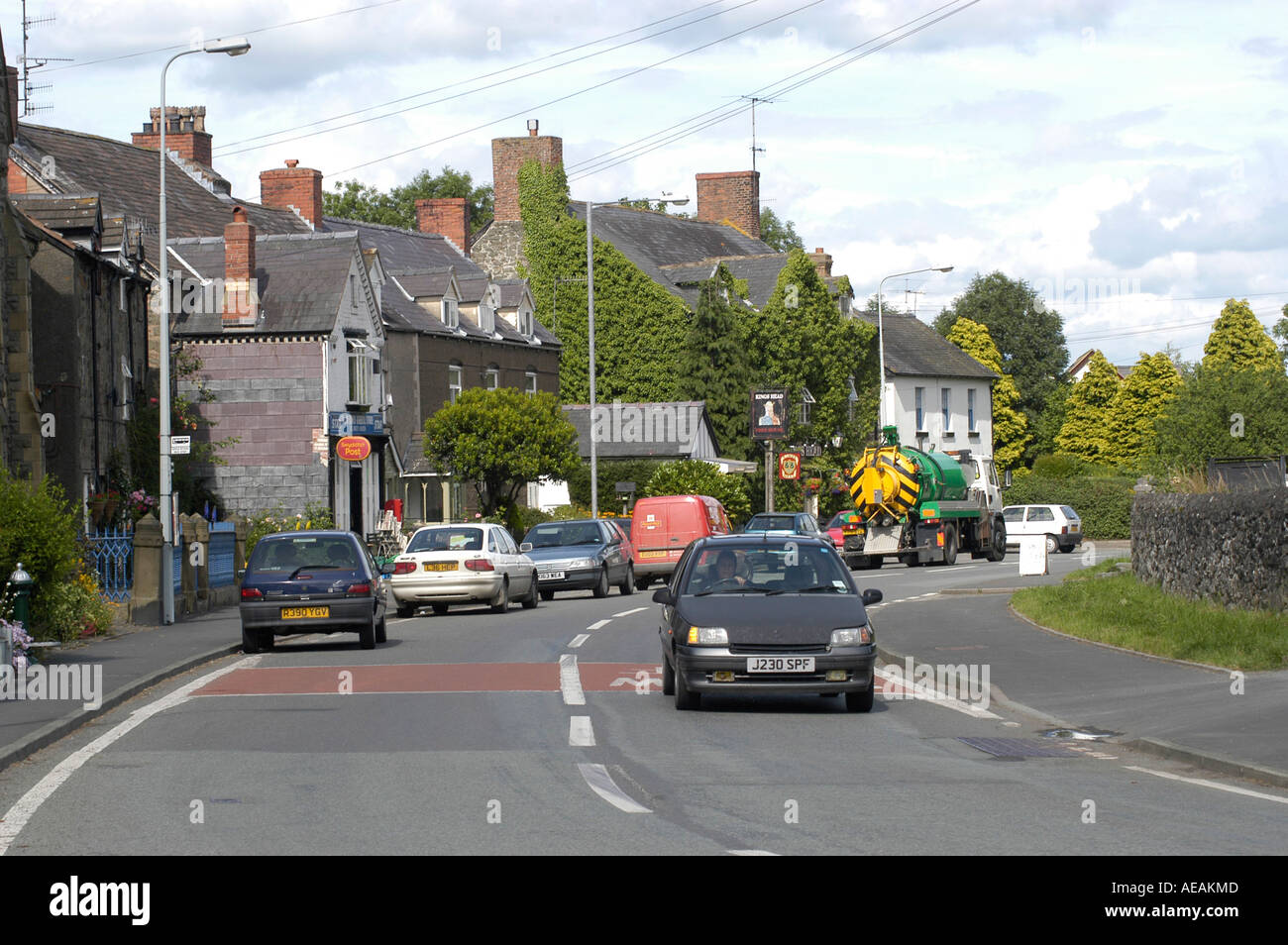 Traffic travelling through the main street of Meifod village Powys ...