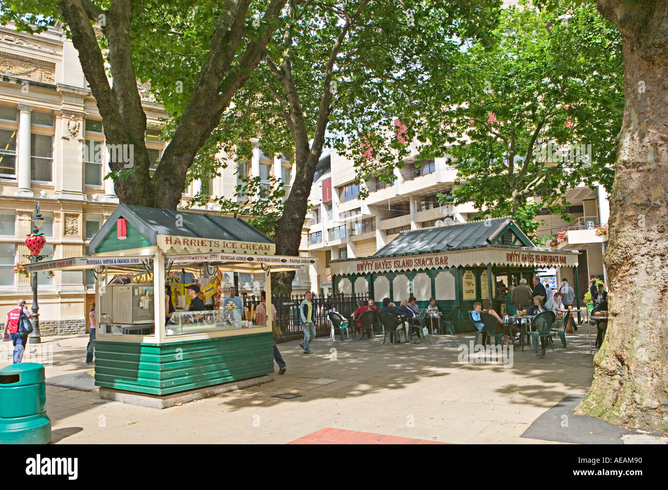 Vendor stands on pedestrian island the Hayes Cardiff city centre Wales ...