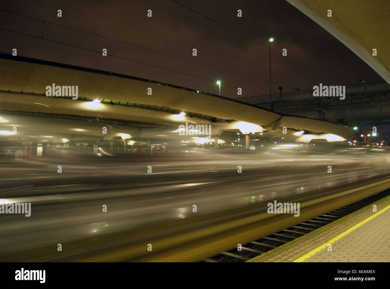 Train passing by station platform at high speed Stock Photo - Alamy