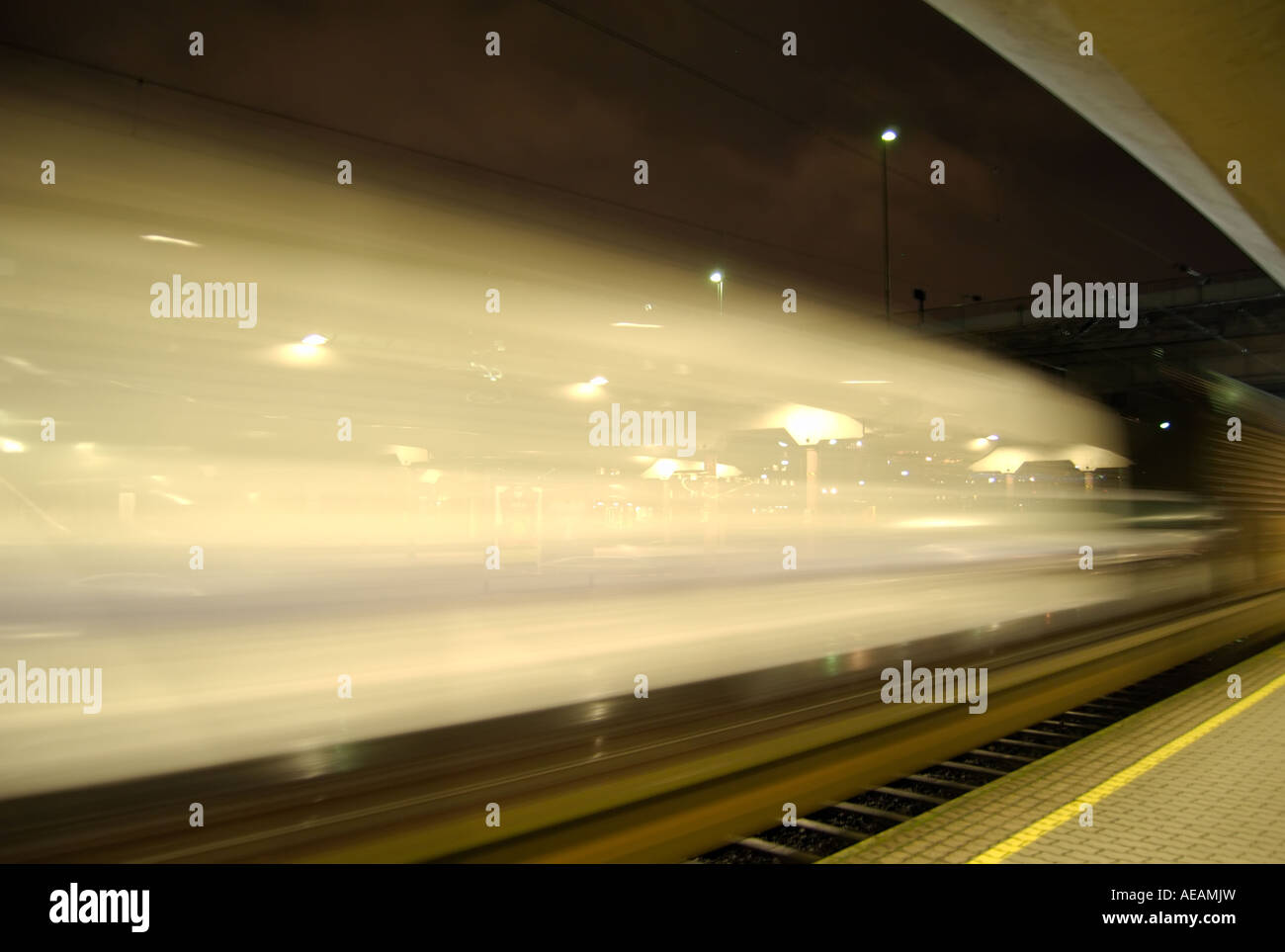 Train passing by station platform at high speed Stock Photo - Alamy