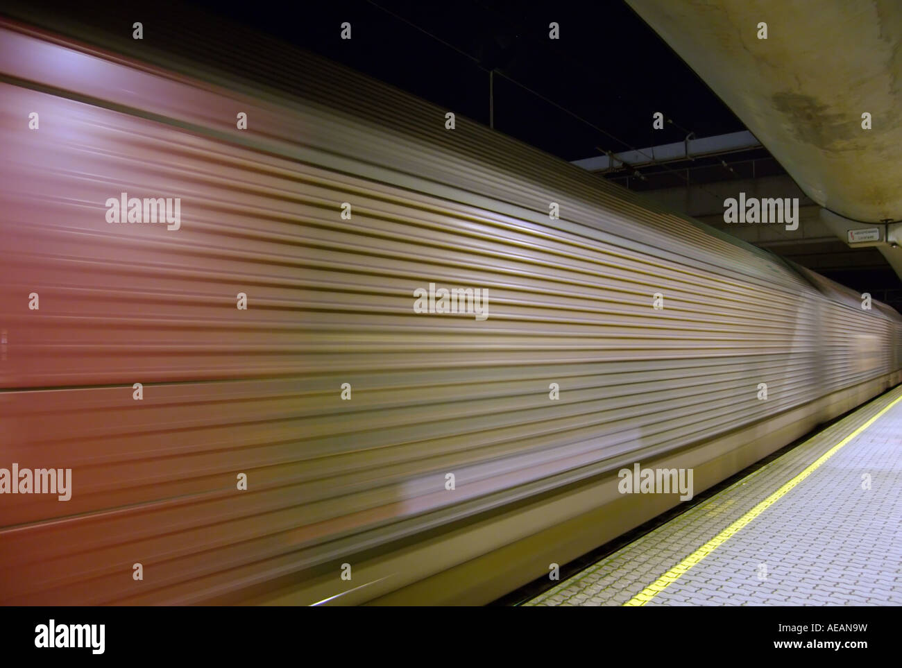 Train passing by station platform at high speed Stock Photo - Alamy