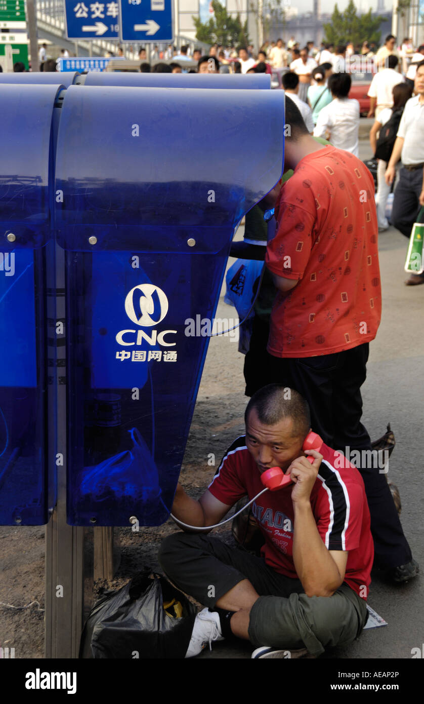 A chinese man makes a phone call at CNC booth in Tianjin raiway station ...