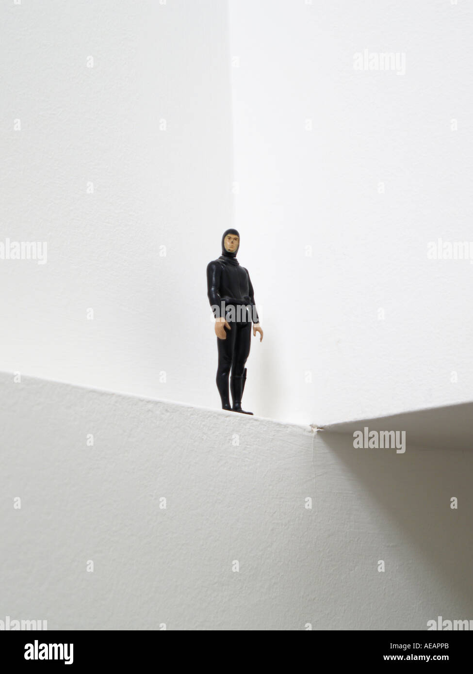 Figure standing on a ledge Stock Photo - Alamy