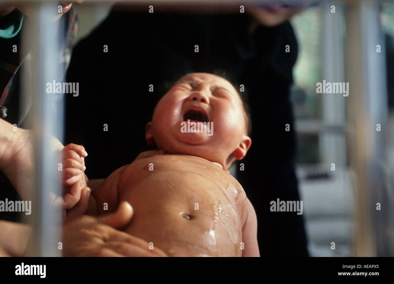 A Chinese baby crying while having a shower Stock Photo - Alamy