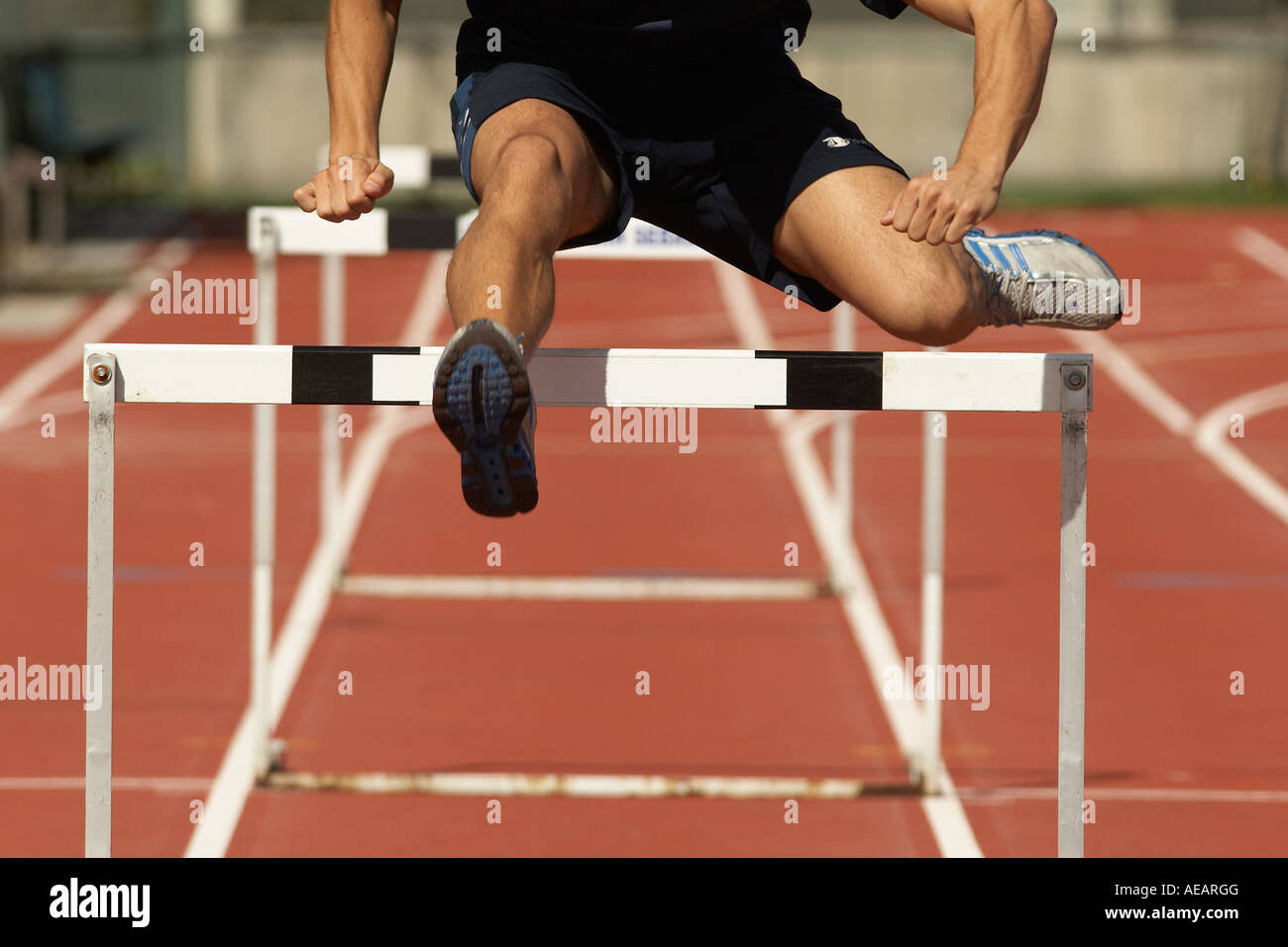 Track and field Man doing hurdles Stock Photo - Alamy