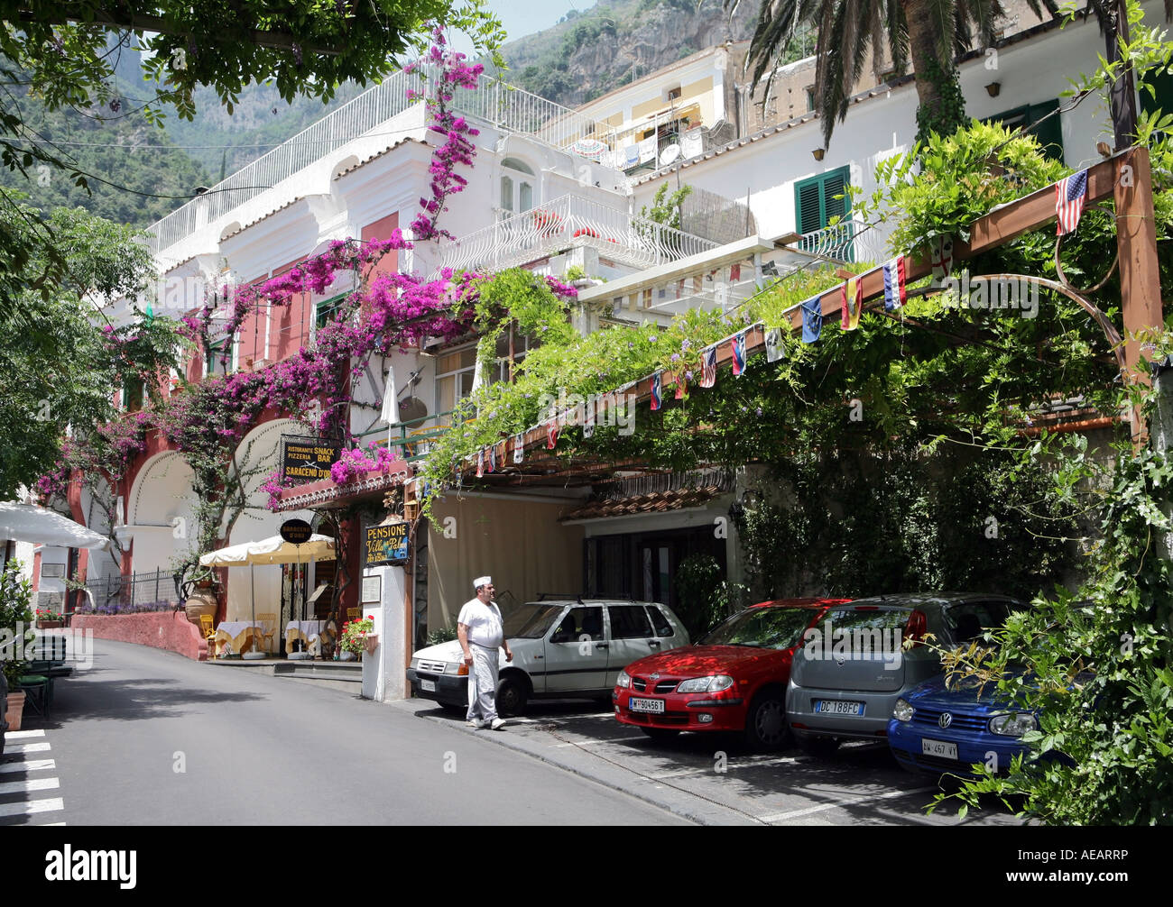 A street with blooming flowers in Positano village on Costiera ...
