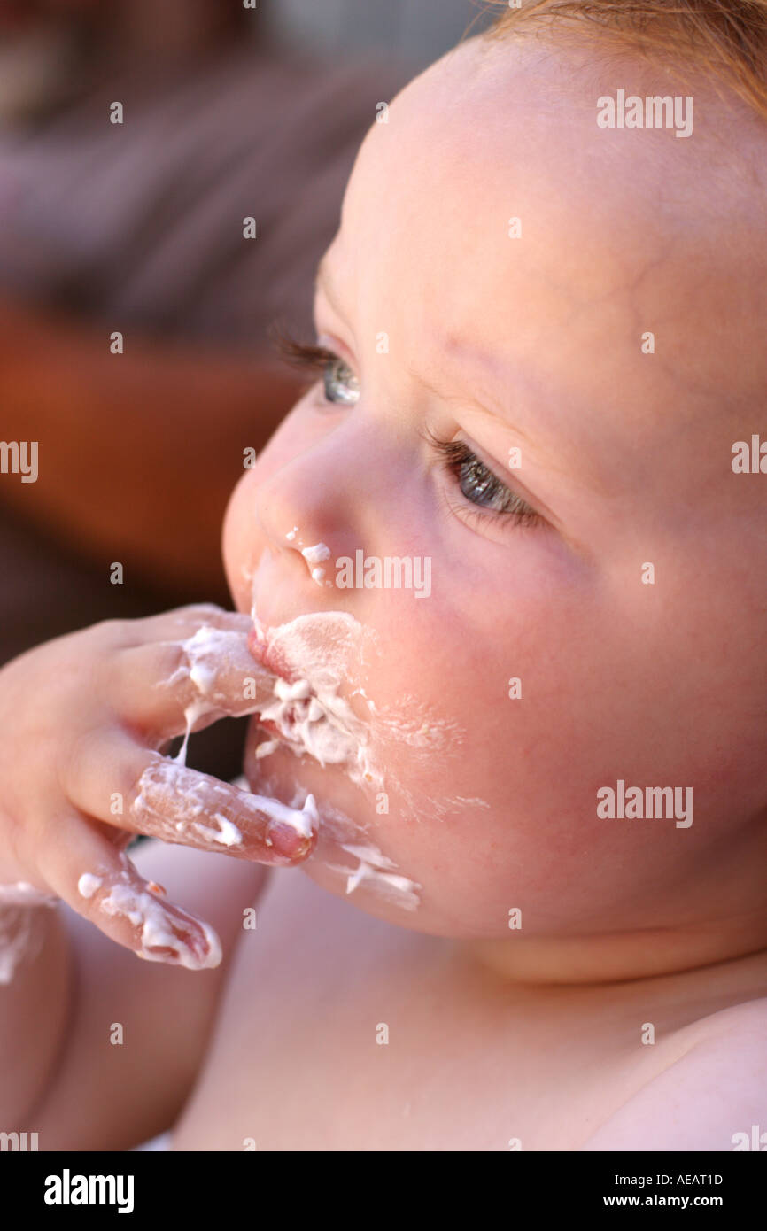 Young boy eating cake on his first birthday Stock Photo - Alamy