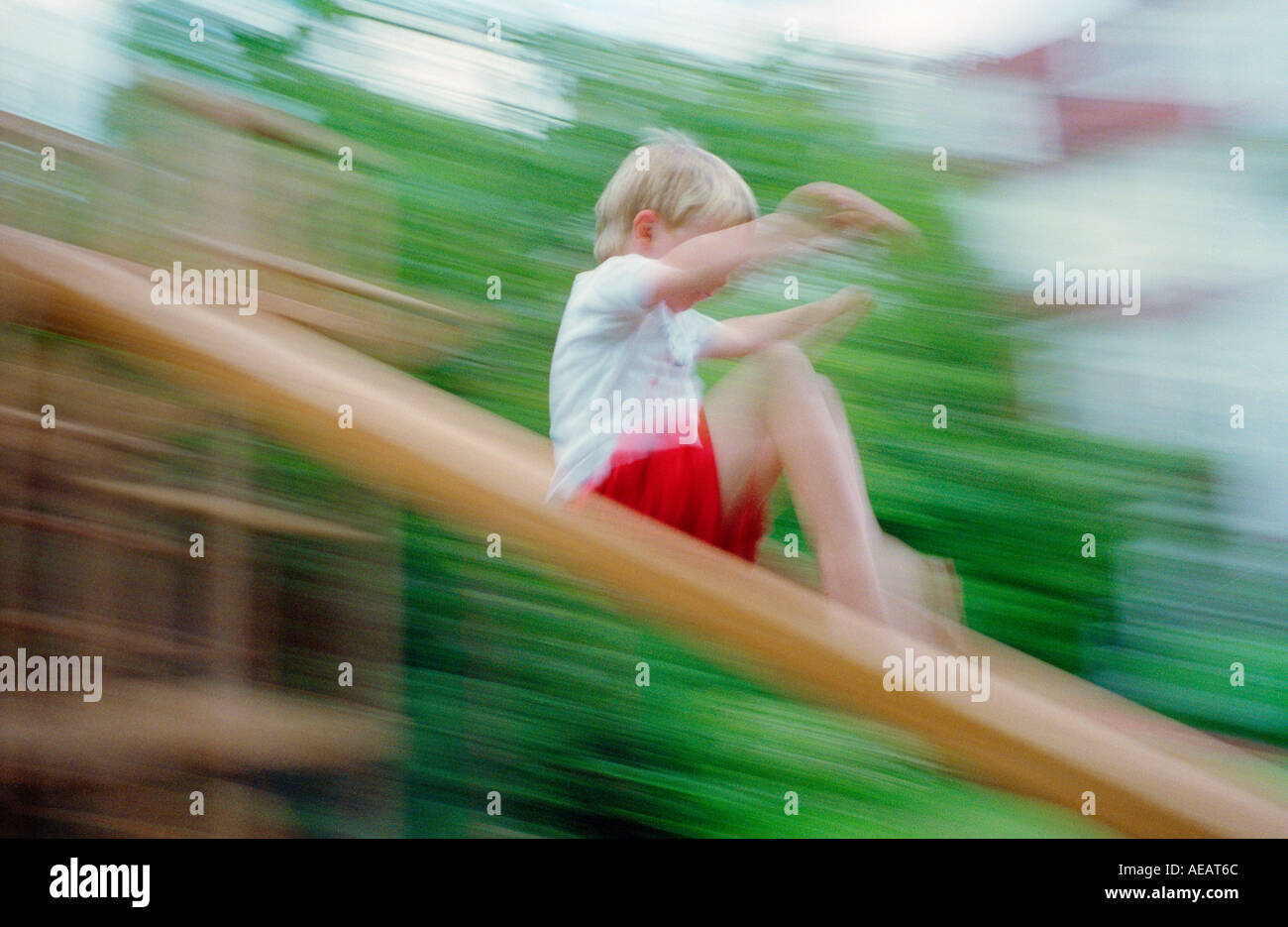 Boy Playing on a Slide England Stock Photo - Alamy