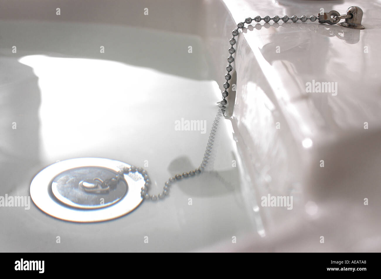 Image of a basin full of water, showing a plug holding water Stock ...