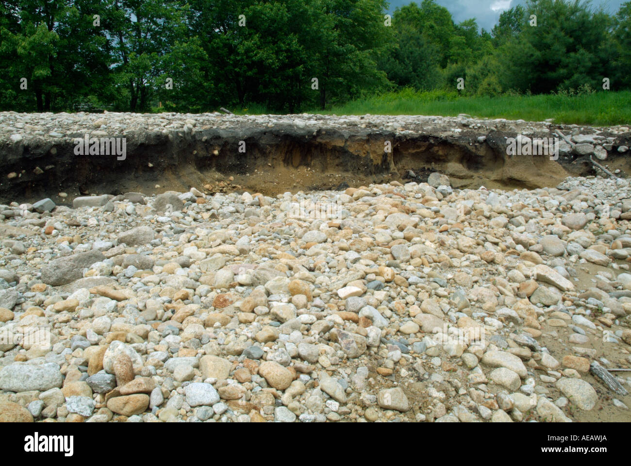 A section of washed out road from water over flowing a small pond Stock ...
