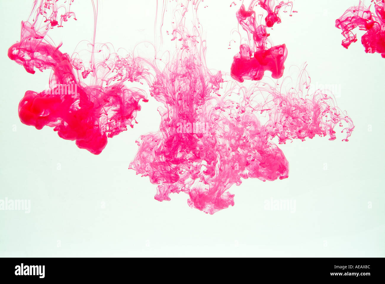 Coloured ink in water creating graphic swirling patterns Stock Photo ...