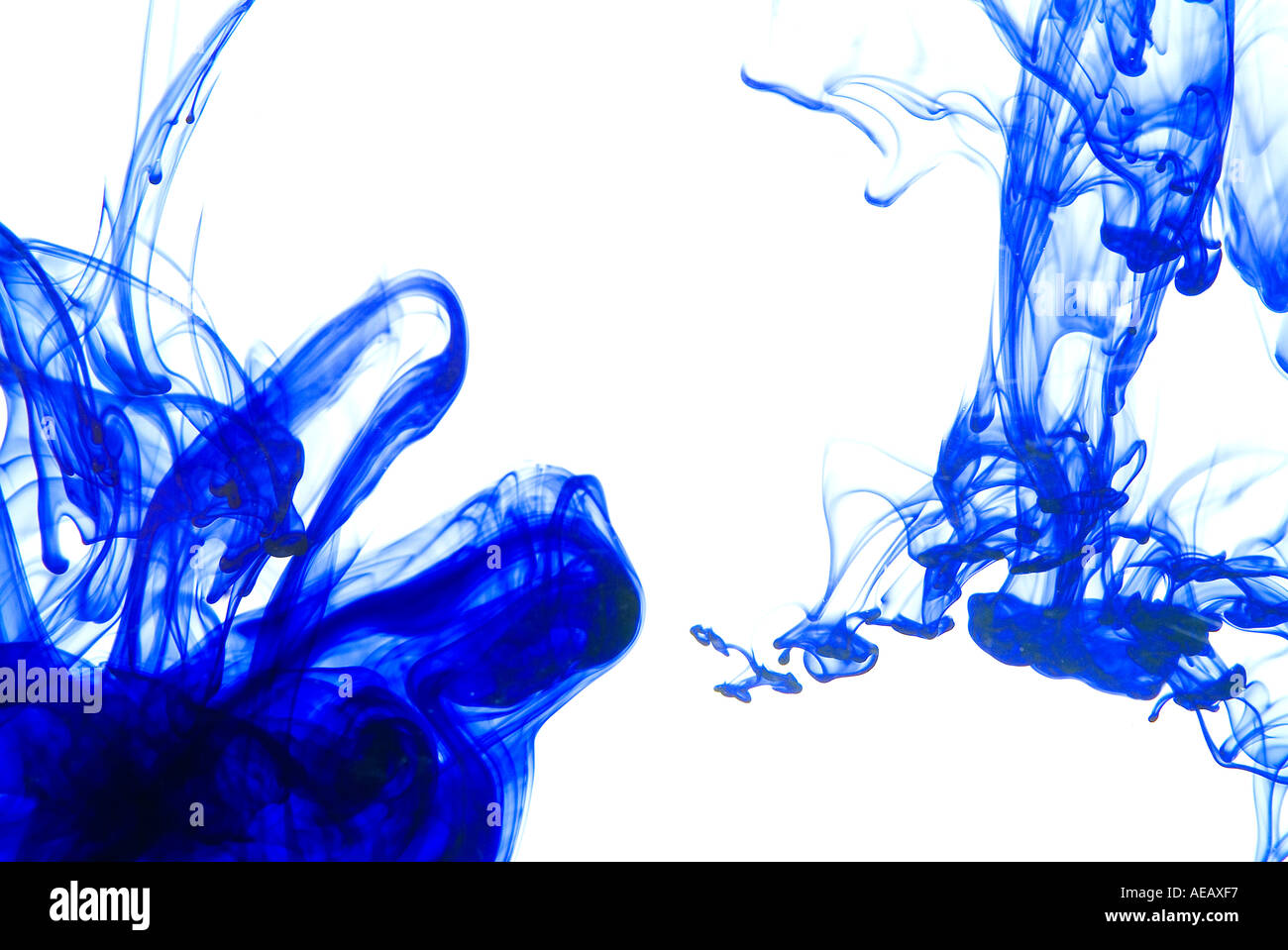 Coloured ink in water creating graphic swirling patterns Stock Photo ...