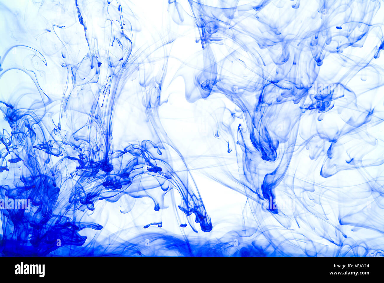 Coloured ink in water creating graphic swirling patterns Stock Photo ...