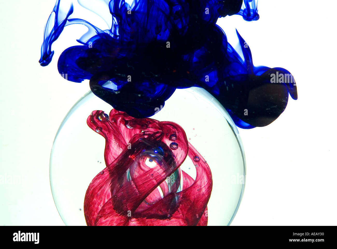 Coloured ink in water creating graphic swirling patterns Stock Photo ...