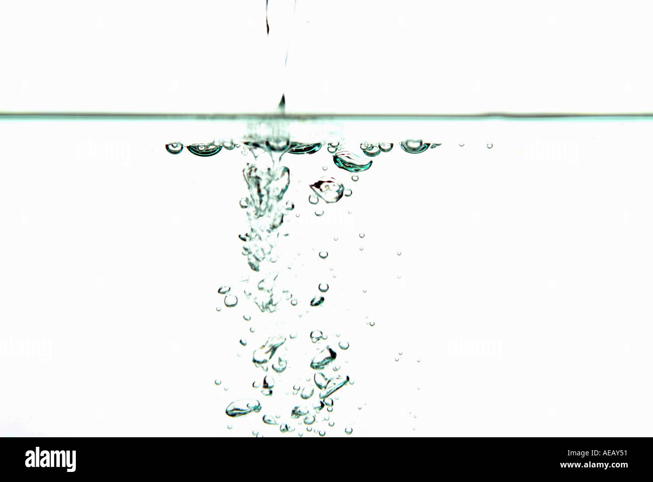 Stream of bubbles created by a stream of water being poured into water ...