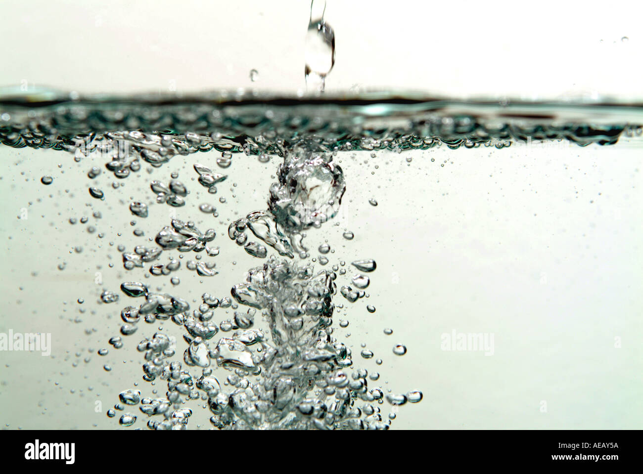 Stream of bubbles created by a stream of water being poured into water ...
