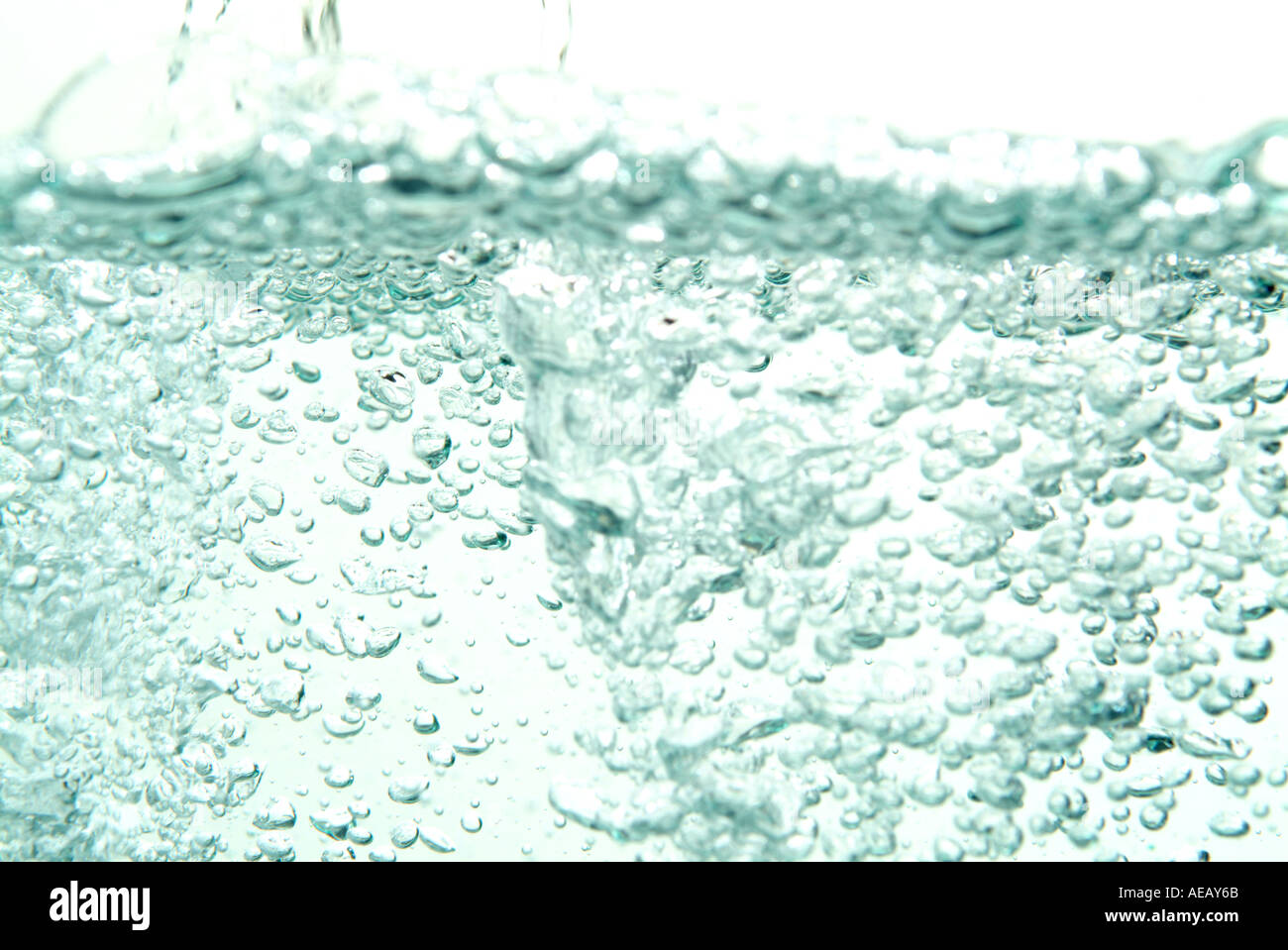 Stream of bubbles created by a stream of water being poured into water ...