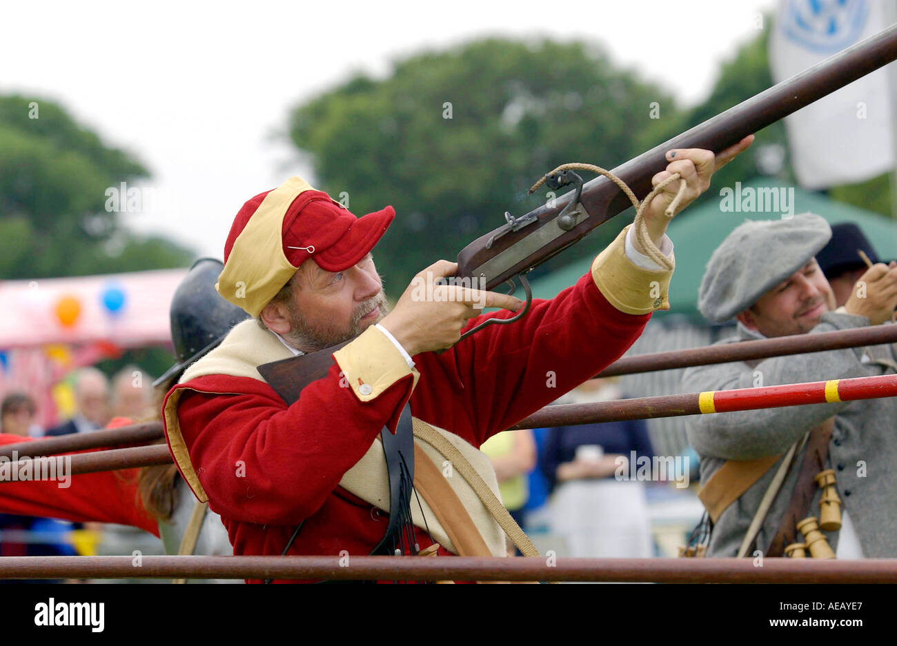 MEMBER OF THE FOOT REGIMENT OF THE SEALED KNOT SOCIETY FIRING A MUSKET ...