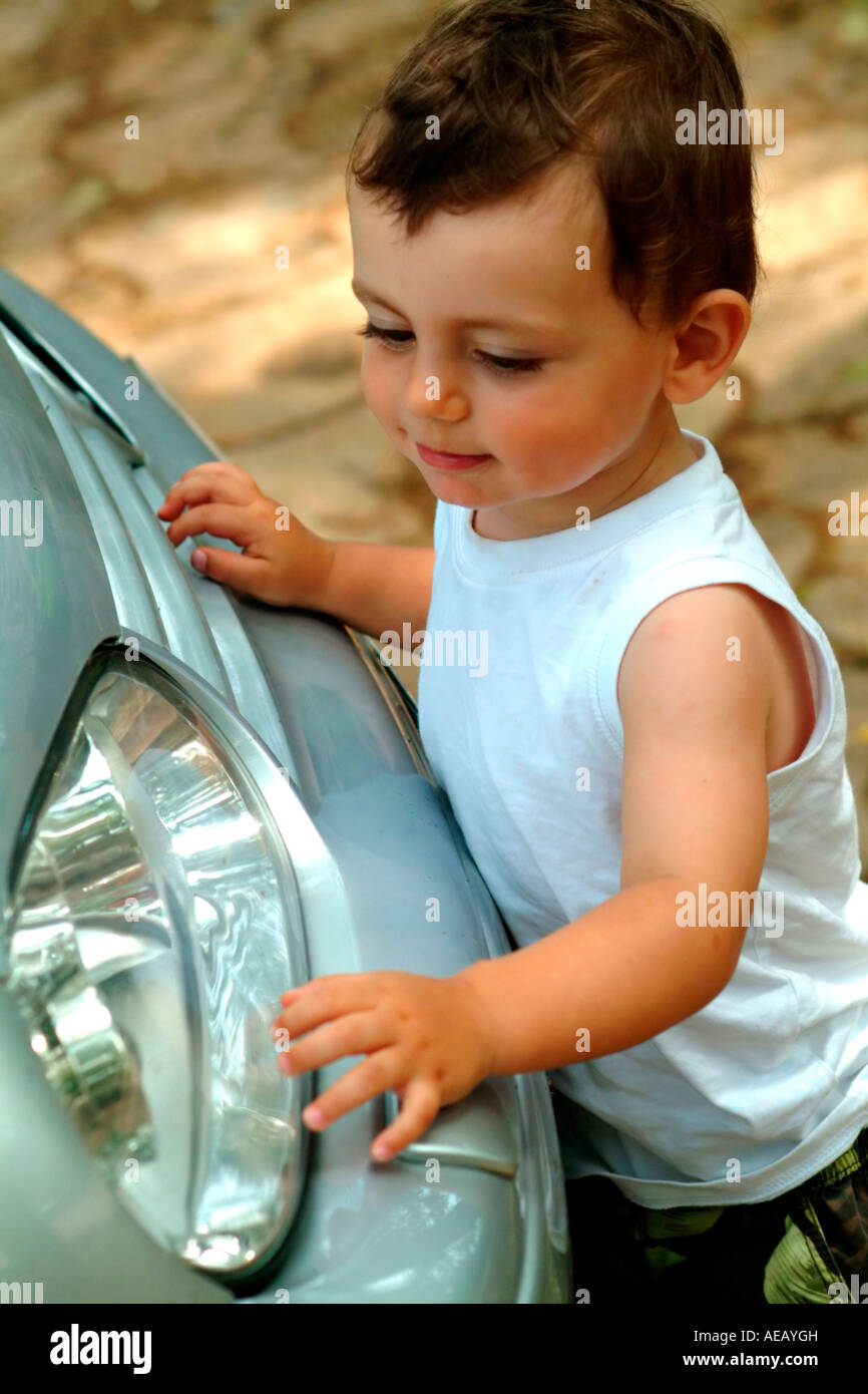 Little boy touching car Stock Photo - Alamy