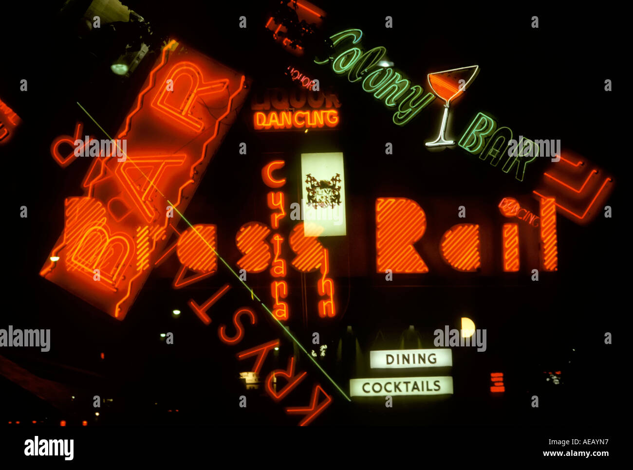 Night time photography of multiple bars signs advertising drinking ...